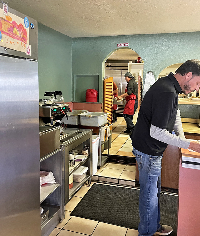 The kitchen staff moves with the choreographed precision that comes only from years of practice. This is where the magic happens, one batch of chile at a time.