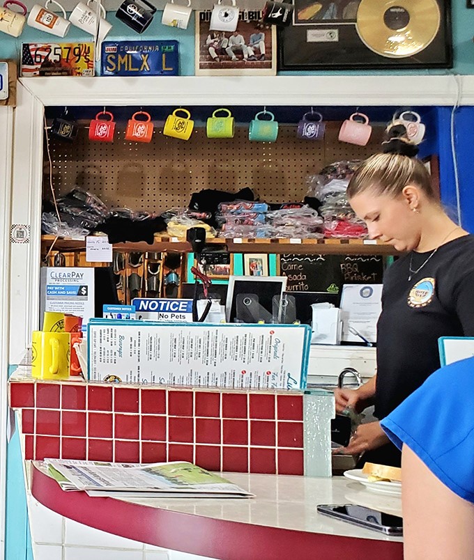 Behind every great breakfast is a dedicated staff member making magic happen. The colorful mugs hanging above are ready for their coffee close-up.