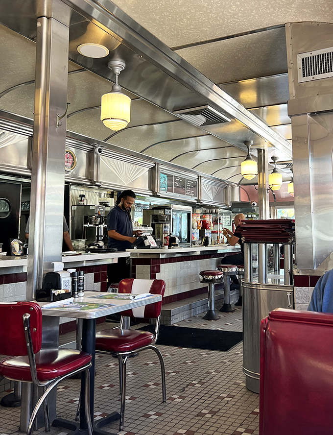 Dedicated staff navigate the narrow aisles with practiced grace, balancing plates of pancakes and mugs of coffee with impressive dexterity.