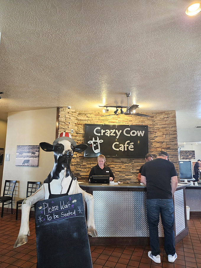 Greeted by a life-sized cow holding the "Please Wait" sign&mdash;because when food is this good, even the statues have jobs to do.