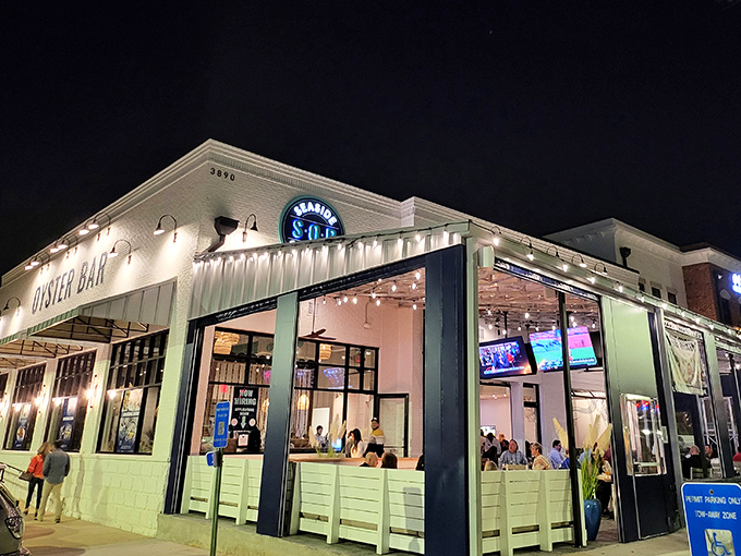 By night, Seaside Oyster Bar transforms into a glowing oasis of culinary delights &ndash; like a lighthouse guiding hungry souls to seafood salvation.