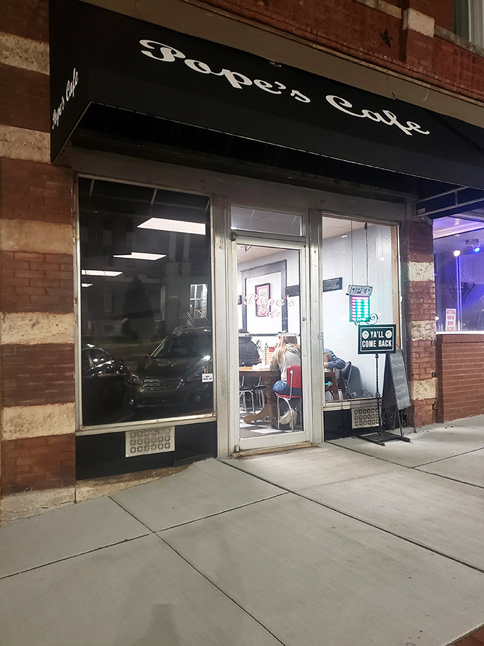 As evening falls, Pope's Cafe's warm glow beckons like an old friend saying, "Come on in, we've saved you a seat at the table."