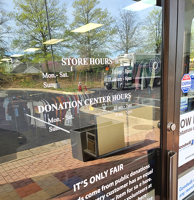 Store hours posted clearly&mdash;the roadmap to your treasure hunting expedition. The "It's Only Fair" motto reminds us of Goodwill's greater purpose.