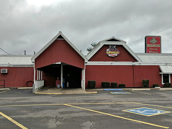 Even under cloudy skies, Brangus Steakhouse's distinctive red exterior serves as a beacon for hungry travelers seeking honest-to-goodness Arkansas beef.