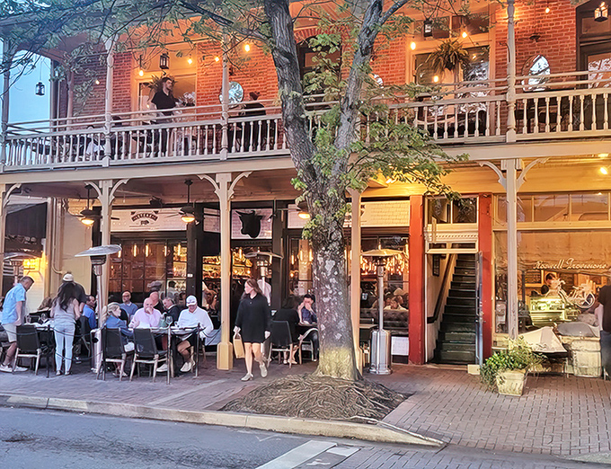 As evening falls, Little Alley transforms into a glowing beacon of culinary promise. The outdoor seating under twinkling lights creates the perfect stage for memorable meals.