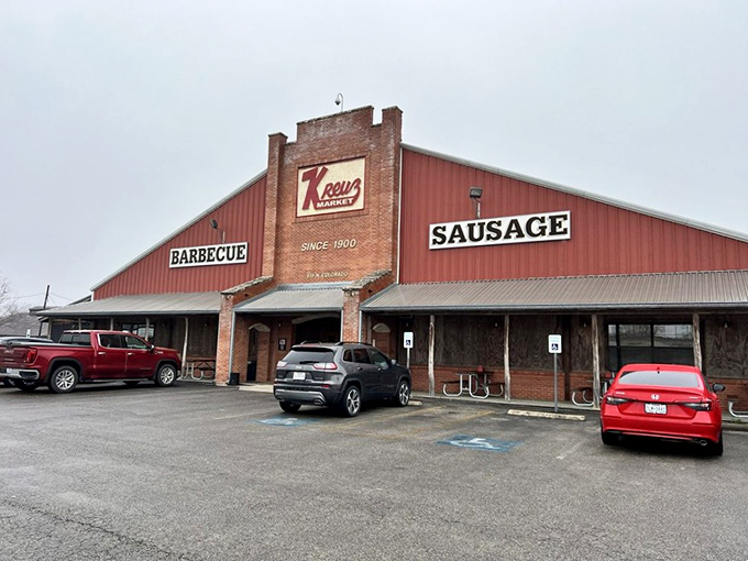 The red-trimmed exterior stands like Texas barbecue royalty, beckoning hungry travelers with its siren call of "BARBECUE" and "SAUSAGE."