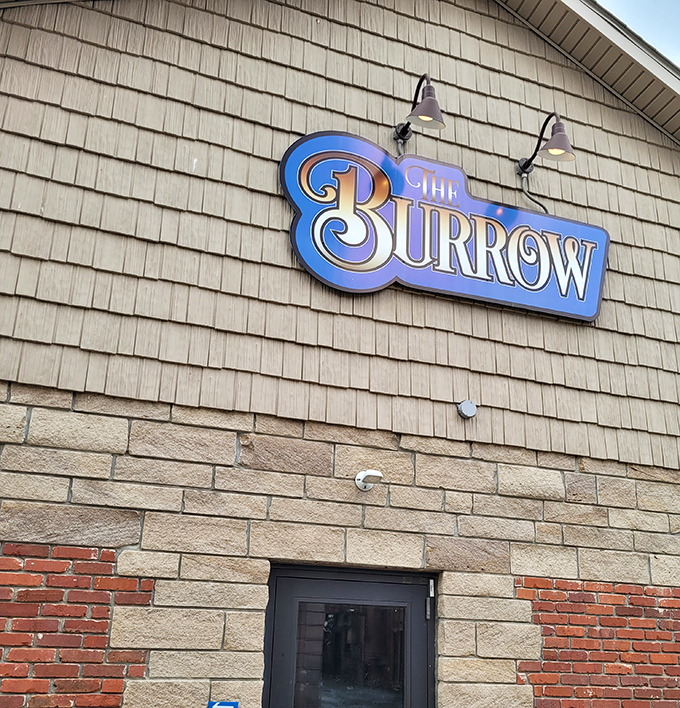 The Burrow's sign suggests a cozy hideaway where locals gather to escape winter chills and share stories that get better with each telling.