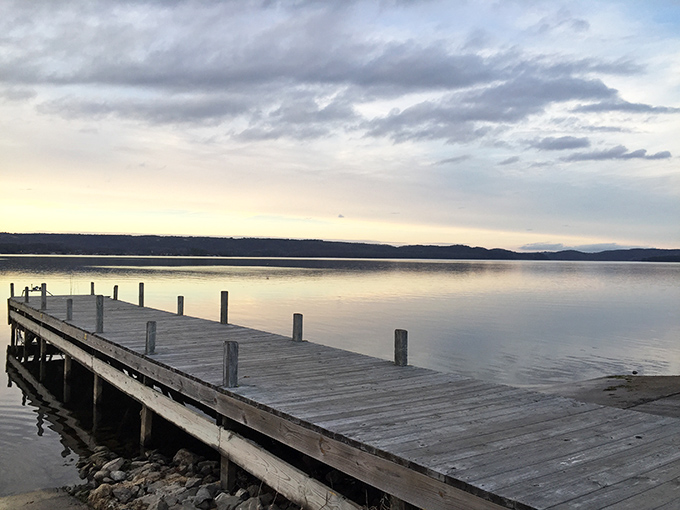 This weathered dock extends an invitation to slow down and appreciate the simple magic of a lake at dusk&mdash;no admission fee required.