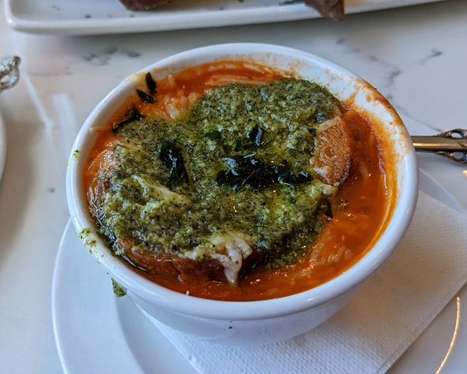 This tomato bisque topped with pesto isn't just soup&mdash;it's a warm hug in a bowl, waiting to comfort your soul.