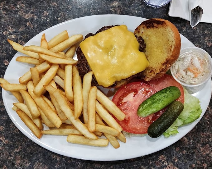 The burger that launched a thousand napkins &ndash; melted cheese, golden fries, and all the fixings arranged with unpretentious precision.