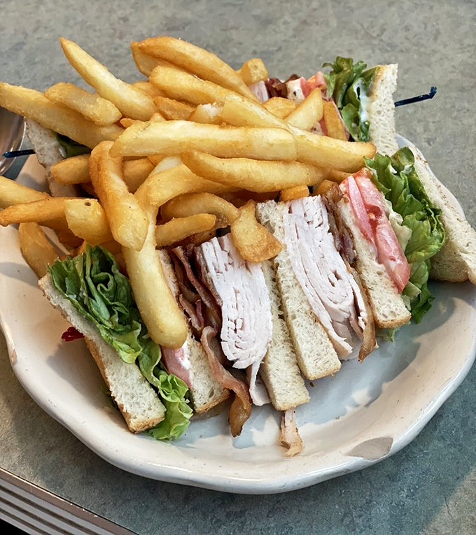 The club sandwich—architecture you can eat. Skyscrapers of turkey, bacon, and toast that would make the Empire State Building jealous.