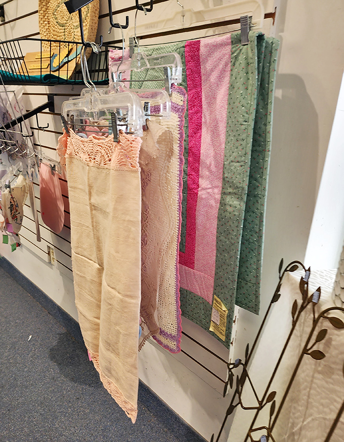 Vintage linens and delicate textiles hang like art pieces. Grandmother's handwork gets new appreciation in these carefully preserved treasures.