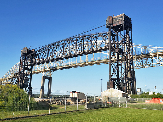 The nearby Soo Locks bridge frames the Michigan experience perfectly—industrial strength engineering, just like the burgers served nearby.
