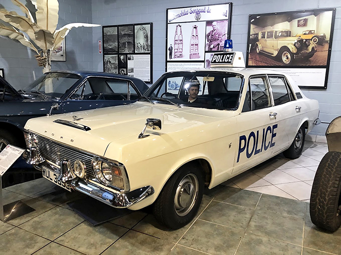 This vintage police cruiser looks ready for its close-up in a 1960s crime drama. Its pristine white paint and bold "POLICE" lettering command respect.