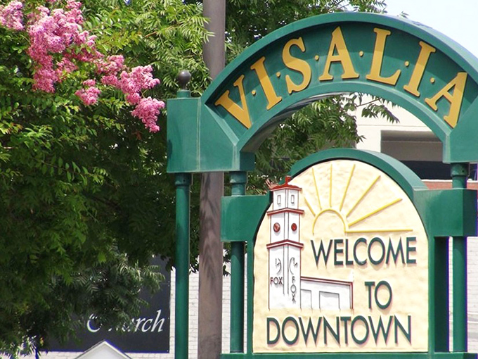 Flowering trees frame Visalia's welcoming downtown arch, inviting visitors to discover California living that won't empty their retirement accounts.