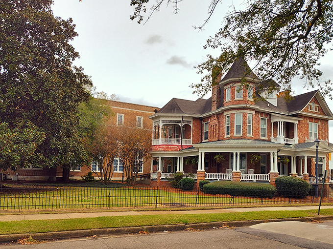 The W.N. Puckett House stands as a brick testament to Victorian craftsmanship, where wraparound porches and turrets speak of a more gracious era.