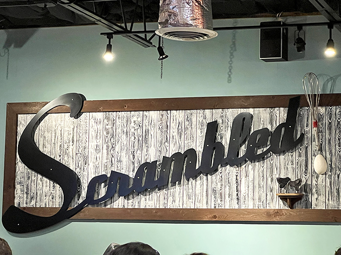 That vintage-style Scrambled sign on weathered wood captures the diner's blend of nostalgia and modern Southern breakfast excellence perfectly.