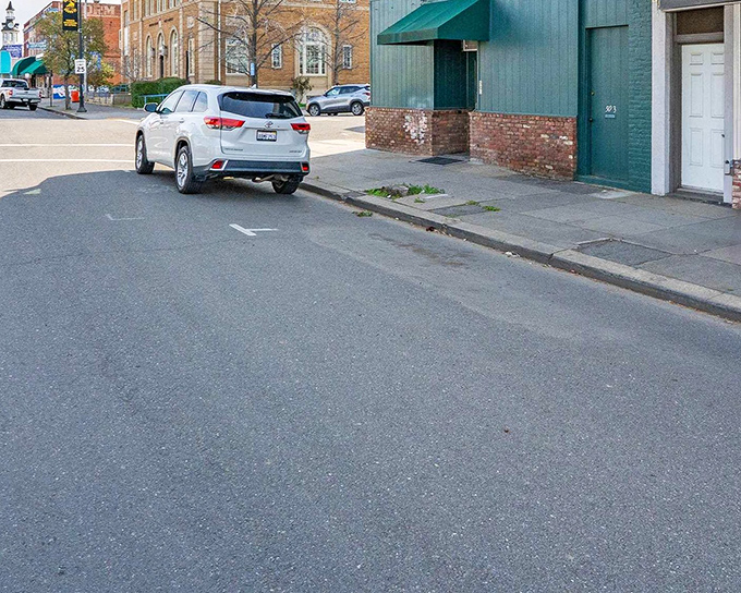 Wide sidewalks made for actual walking, with colorful planters and string lights creating the kind of Main Street that exists mostly in nostalgic movies elsewhere.