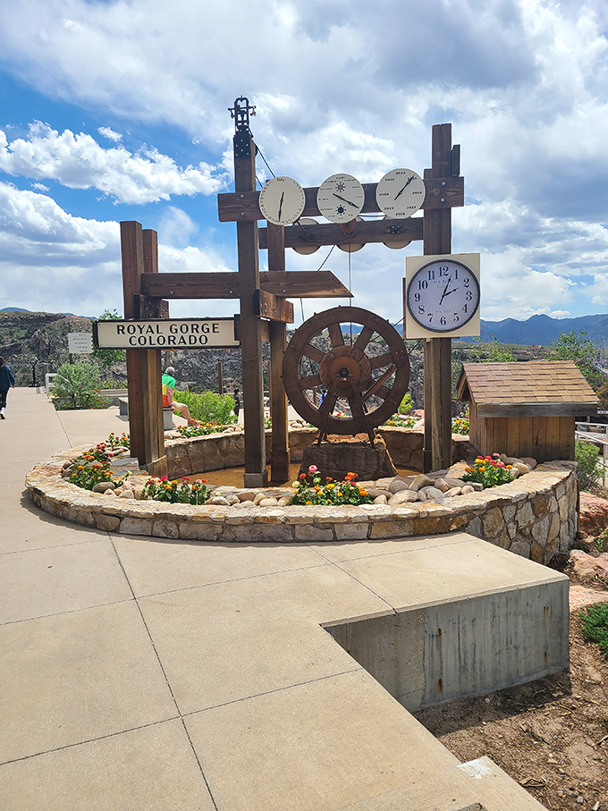 The whimsical water clock and ship's wheel stand as quirky guardians at the Royal Gorge, where time seems to slow down for those who visit.
