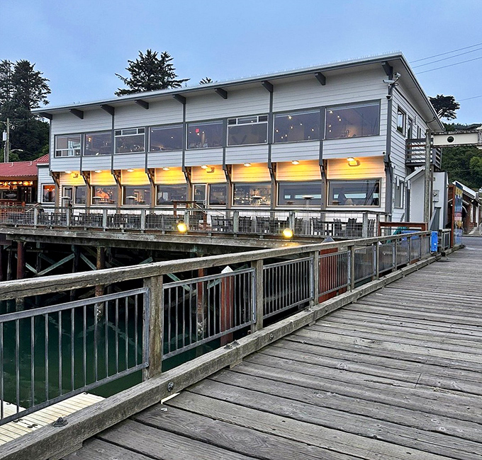 Evening glow transforms this humble building into a beacon for anyone seeking memorable coastal dining experiences.