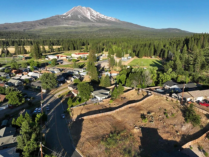 An aerial view reveals Weed's perfect positioning beneath Mount Shasta. From above, you can see why residents trade big-city amenities for this postcard-worthy panorama.