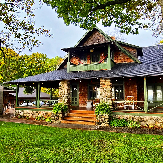 This craftsman-style cottage with its stone pillars and cedar shakes captures the architectural charm that makes Leland homes so distinctively Michigan.