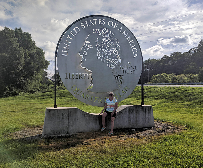 Taking a moment to rest at the base of greatness. The concrete pedestal doubles as the perfect roadside bench for weary travelers.