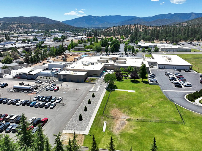 An aerial view reveals Yreka nestled among mountains and forests. Small-town footprint with big-nature surroundings&mdash;the California dream without the California price tag.
