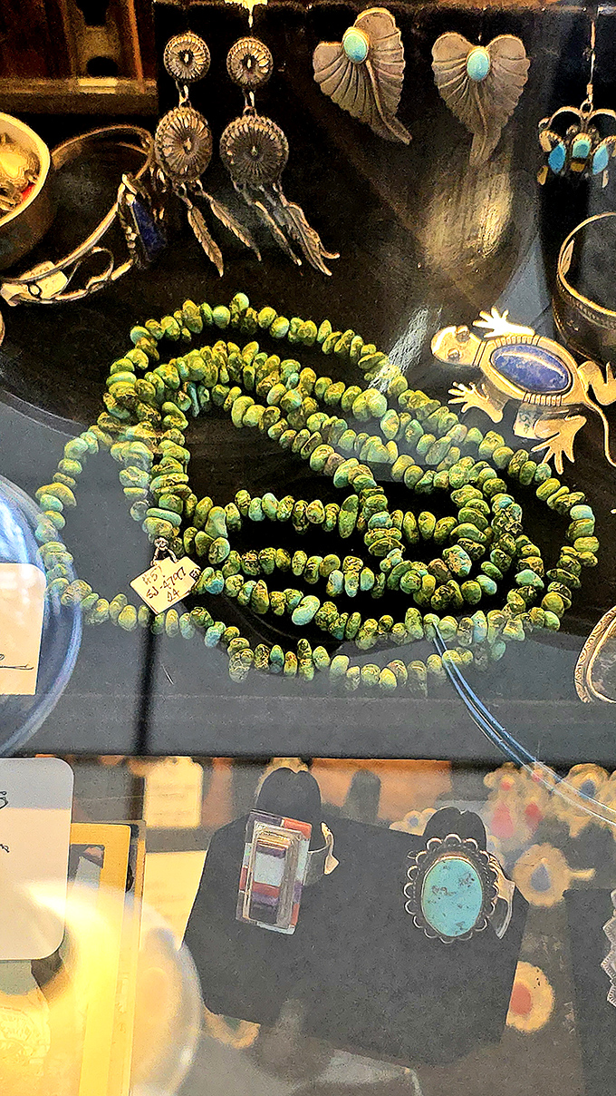 Turquoise jewelry and Southwestern-inspired accessories shimmer under display case lights. These stones have traveled from desert landscapes to Virginia showcases.
