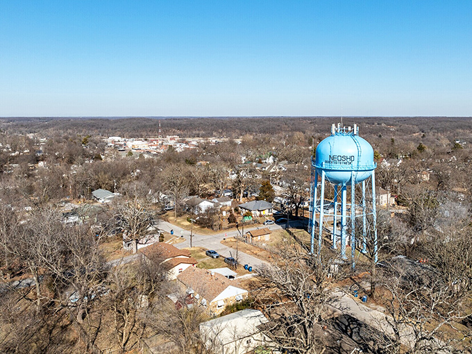 Neosho's iconic blue water tower stands sentinel over a town where the horizon stretches far but community ties run deep.