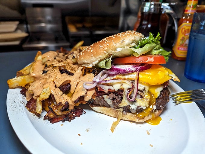 A burger that requires both hands, a stack of napkins, and a moment of silent appreciation before the first magnificent, messy bite.