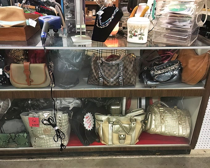 Designer handbags at fraction-of-retail prices line the display case like trophies of the bargain-hunting game. Someone's splurge becomes your steal.