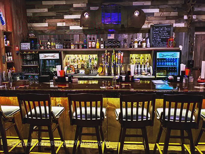 The bar area gleams with promise, offering liquid companions for your barbecue journey. Where bourbon and beer stand ready to enhance those smoky flavors.