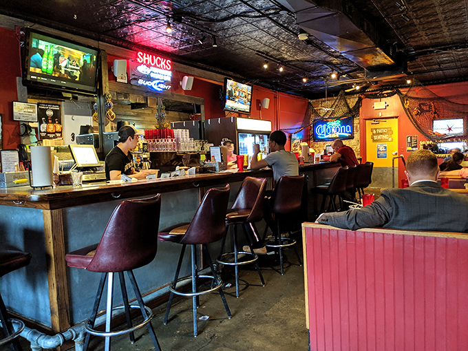 The bar area glows with neon signs and promises of cold drinks, where regulars and first-timers alike gather to celebrate the day's catch.