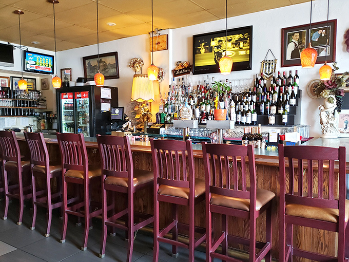 The bar area &ndash; where wine bottles stand at attention like soldiers guarding liquid happiness. Those wooden stools have heard some stories.