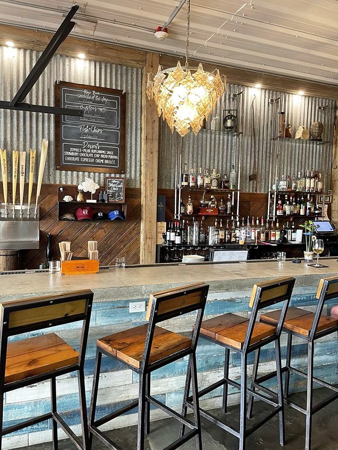 A bar that balances rustic charm with mixology magic. The corrugated metal backdrop and artisanal light fixture create the perfect stage for craft cocktail theater.