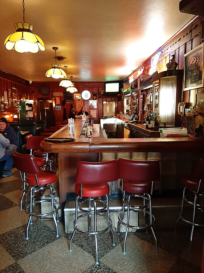 The bar area, with its vintage lighting and red stools, has witnessed decades of celebrations, commiserations, and everyday moments worth remembering.