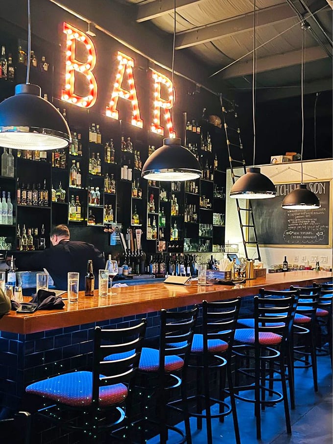 The bar where everybody eventually knows your name. Illuminated by that iconic "BAR" sign, it's where strangers become friends and friends become regulars over perfectly mixed Manhattans.