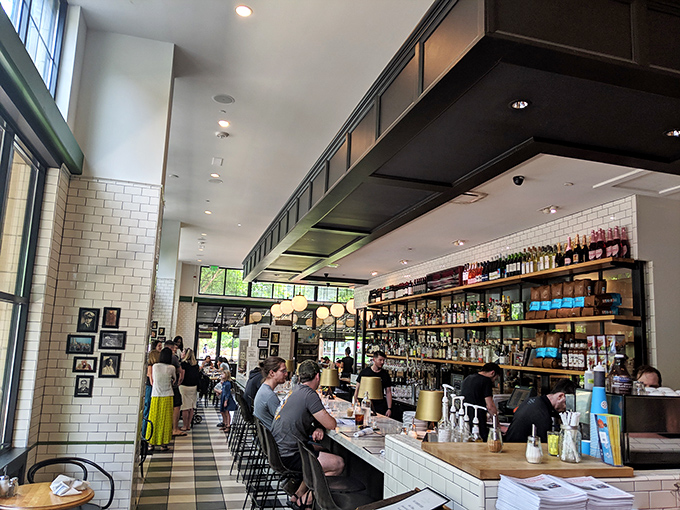 The bar area hums with energy and conversation, a front-row seat to the choreographed dance of hospitality that makes dining here special.