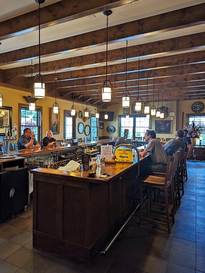 The bar area, where wooden beams overhead match the counter below, creating a space where strangers become friends over stories and cold drinks. 