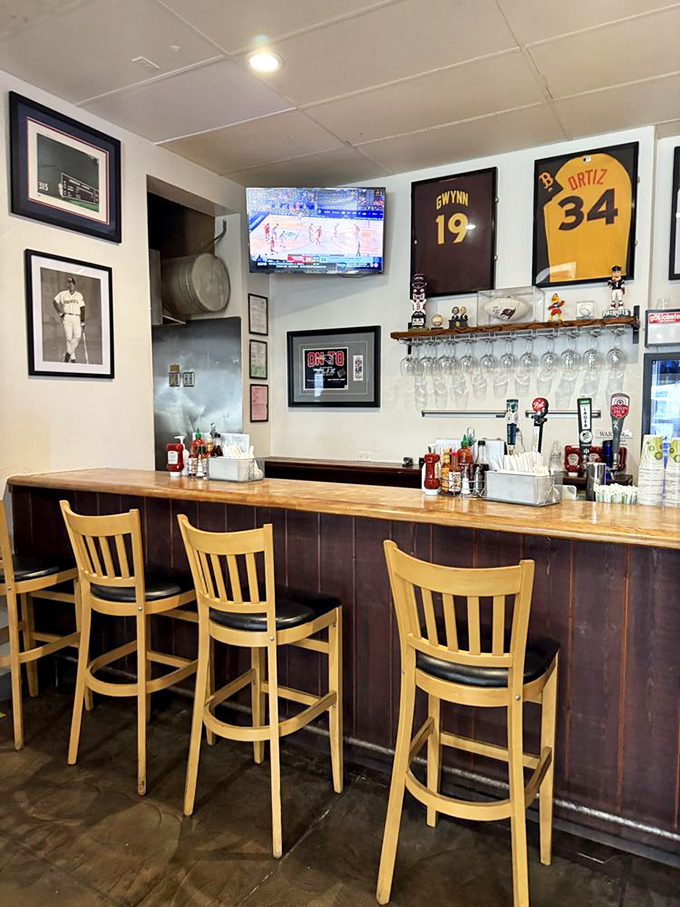 The bar area, complete with sports memorabilia and wooden stools, offers a front-row seat to the game while you tackle your own championship-worthy seafood feast.