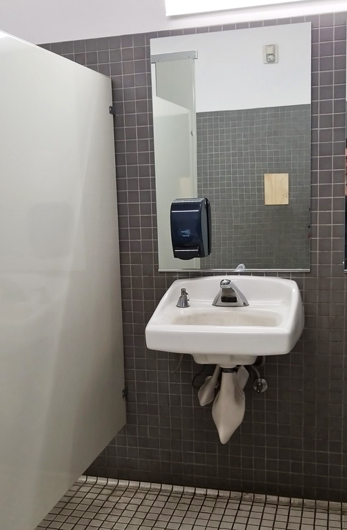 Even the restrooms maintain that no-frills warehouse aesthetic. When nature calls during your treasure hunt, Goodwill answers with utilitarian charm. 