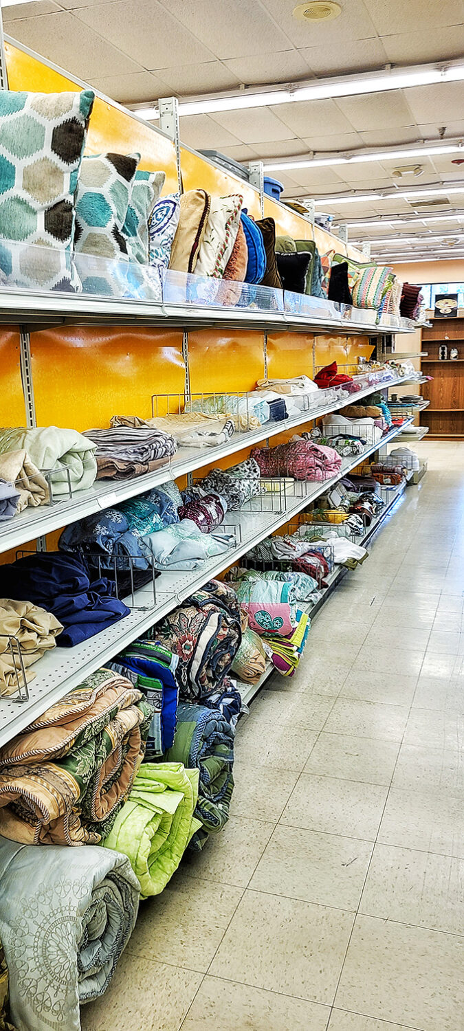 The bedding section: a textile rainbow where yesterday's designer pillows and quilts await their chance to transform your bedroom.