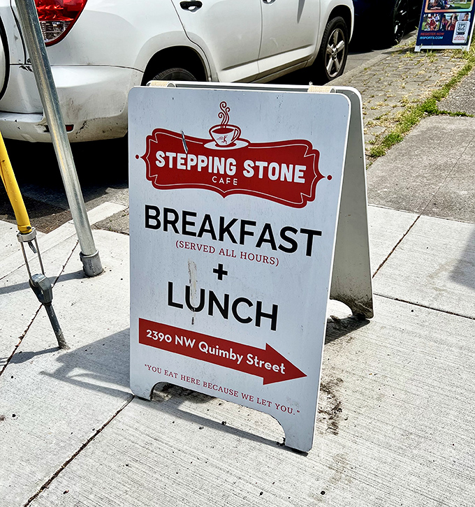 A sidewalk sign that speaks the truth: breakfast served all day because some things shouldn't be rushed.
