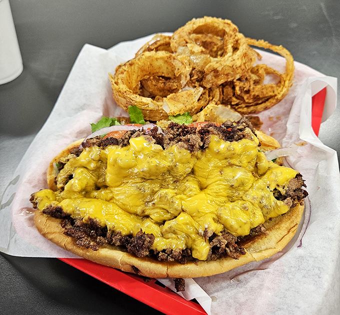 Cheese blankets the beef like a warm Missouri sunset. Those onion rings aren't just garnish&mdash;they're golden halos of happiness.