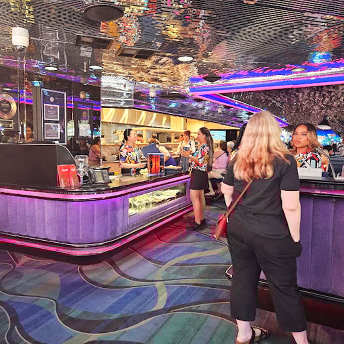 The heart of Peppermill's operation &ndash; where servers in tropical prints navigate the neon-lit interior like colorful fish in an aquarium of retro cool.
