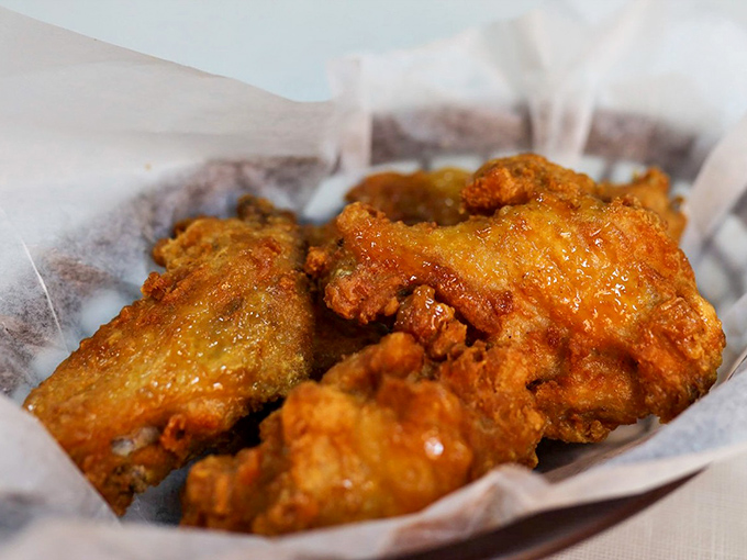 Wings that have achieved the perfect golden-crisp exterior while maintaining juicy tenderness inside – a balancing act worthy of Olympic medals.