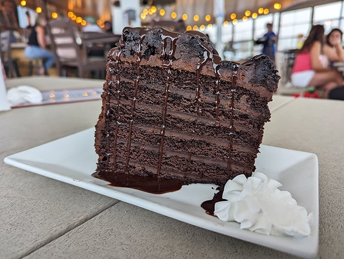A slice of chocolate cake so rich and layered it deserves its own tax bracket &ndash; the perfect sweet finale to a seafood symphony.