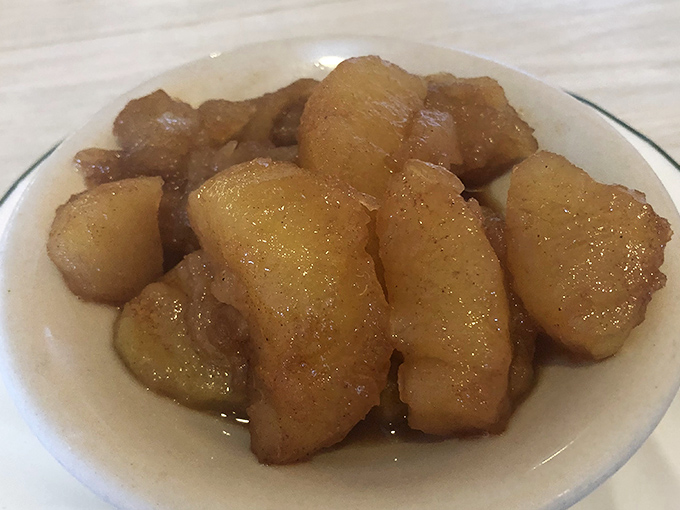 Cinnamon apples that blur the line between side dish and dessert. These glistening, tender slices have been simmering in buttery cinnamon syrup until they surrendered completely.