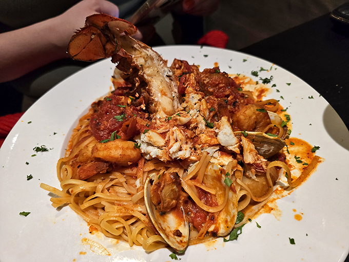 This seafood pasta isn't just dinner&mdash;it's an underwater expedition where lobster, clams, and shrimp have gathered for a tomato-sauced summit meeting on your plate.